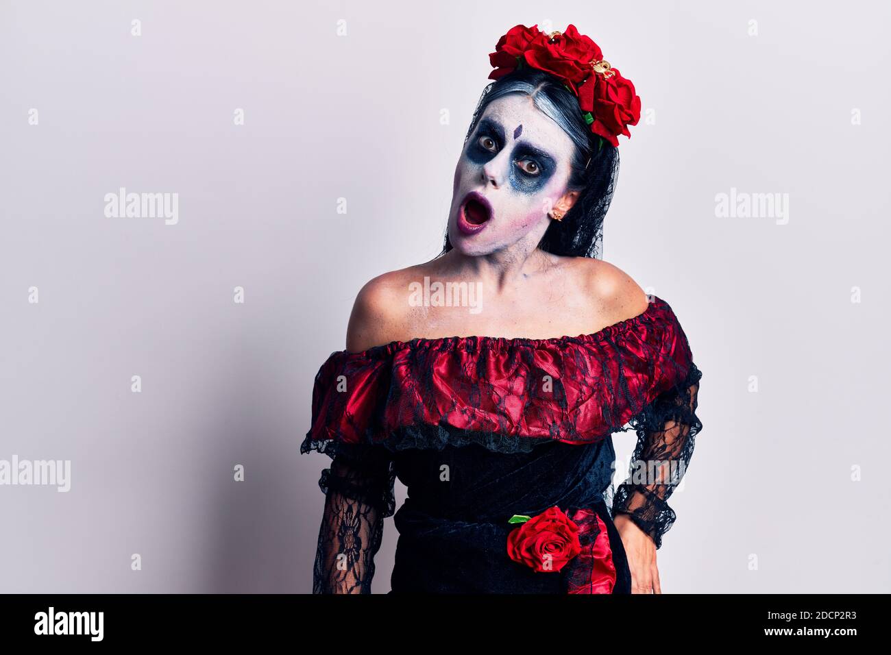 Young woman wearing mexican day of the dead makeup in shock face ...