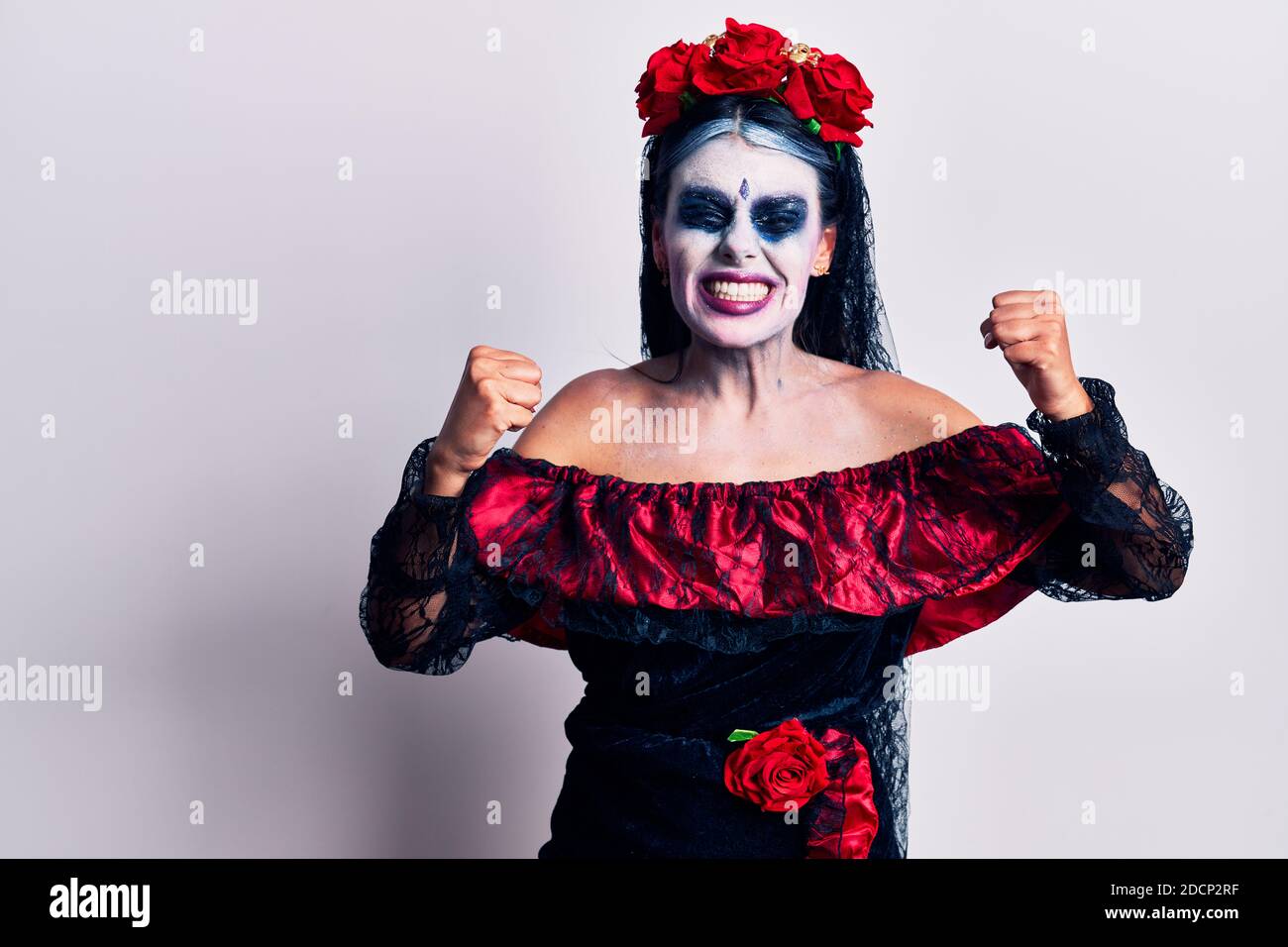 Young woman wearing mexican day of the dead makeup angry and mad ...