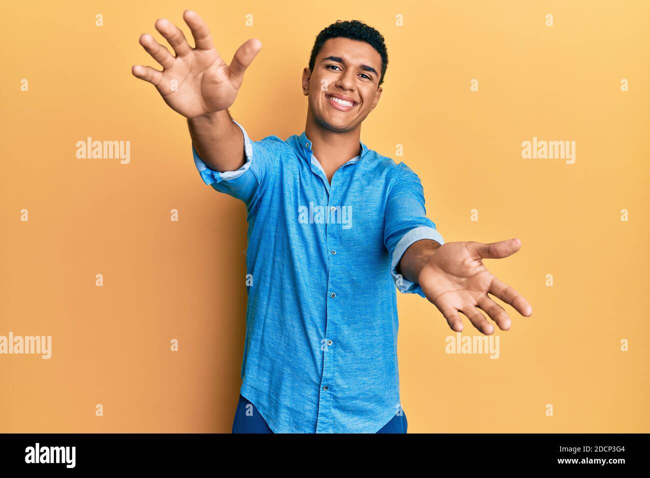 Young arab man wearing casual clothes looking at the camera smiling ...