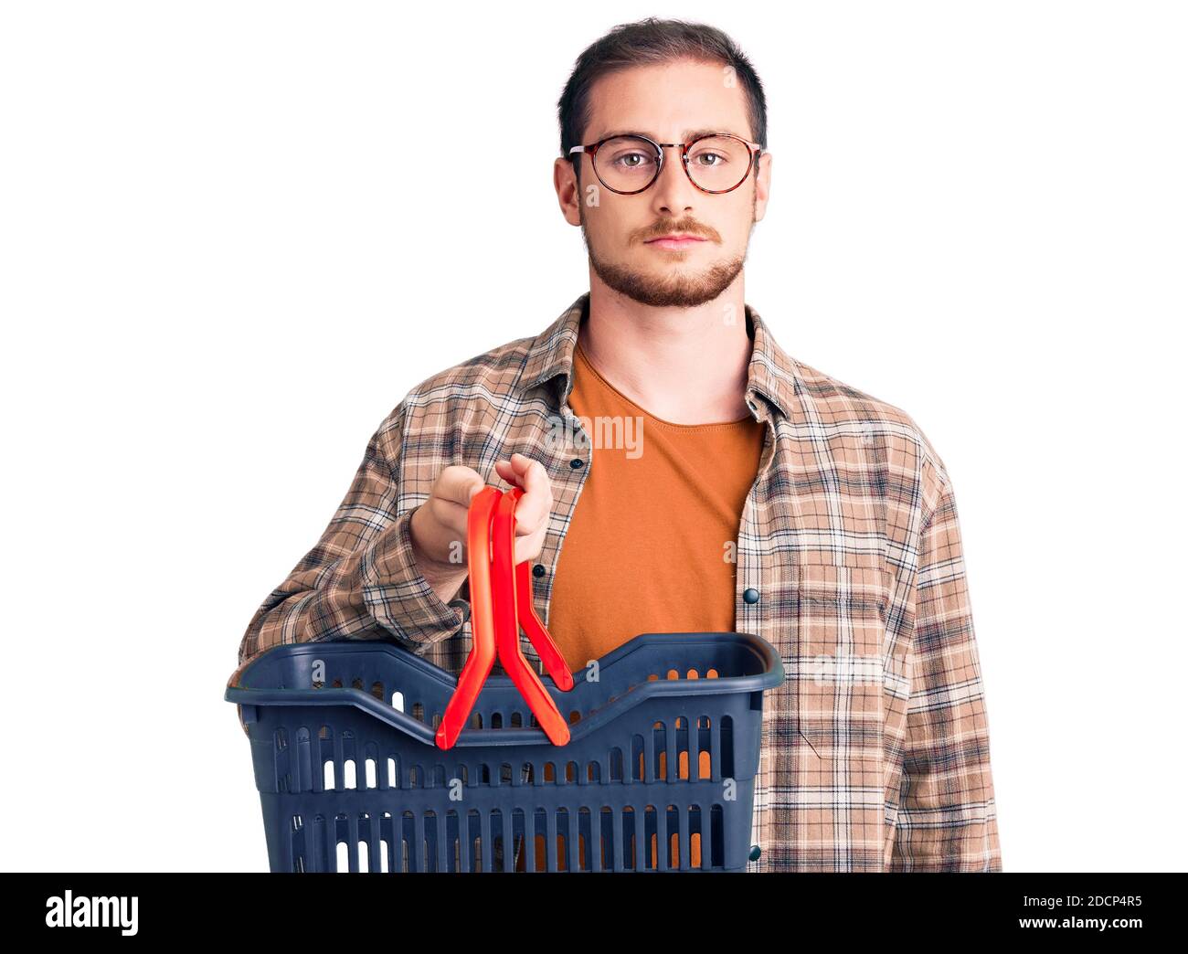 Young handsome caucasian man holding supermarket shopping basket ...