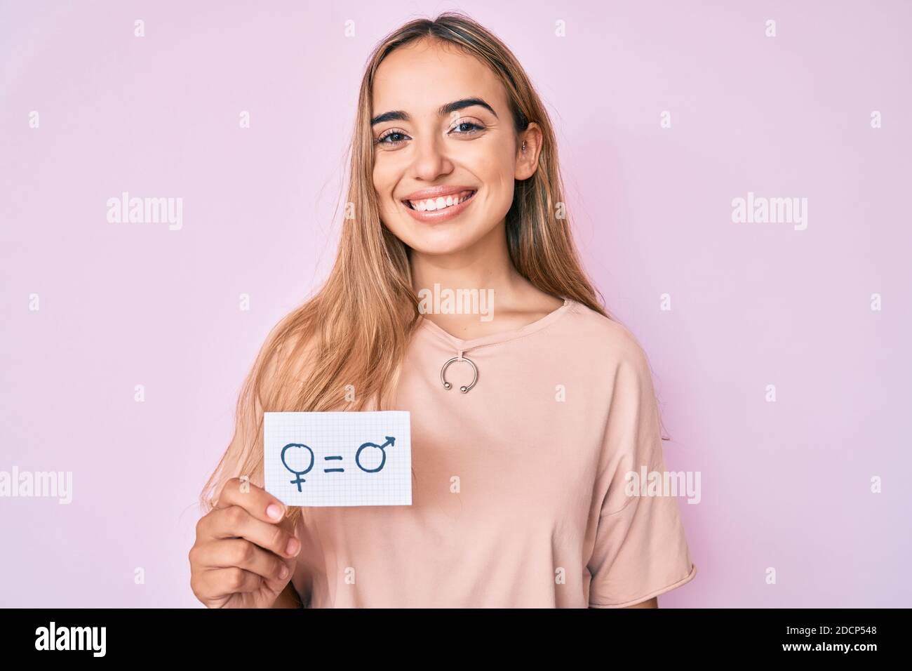 Young beautiful blonde woman holding we are equal paper looking ...