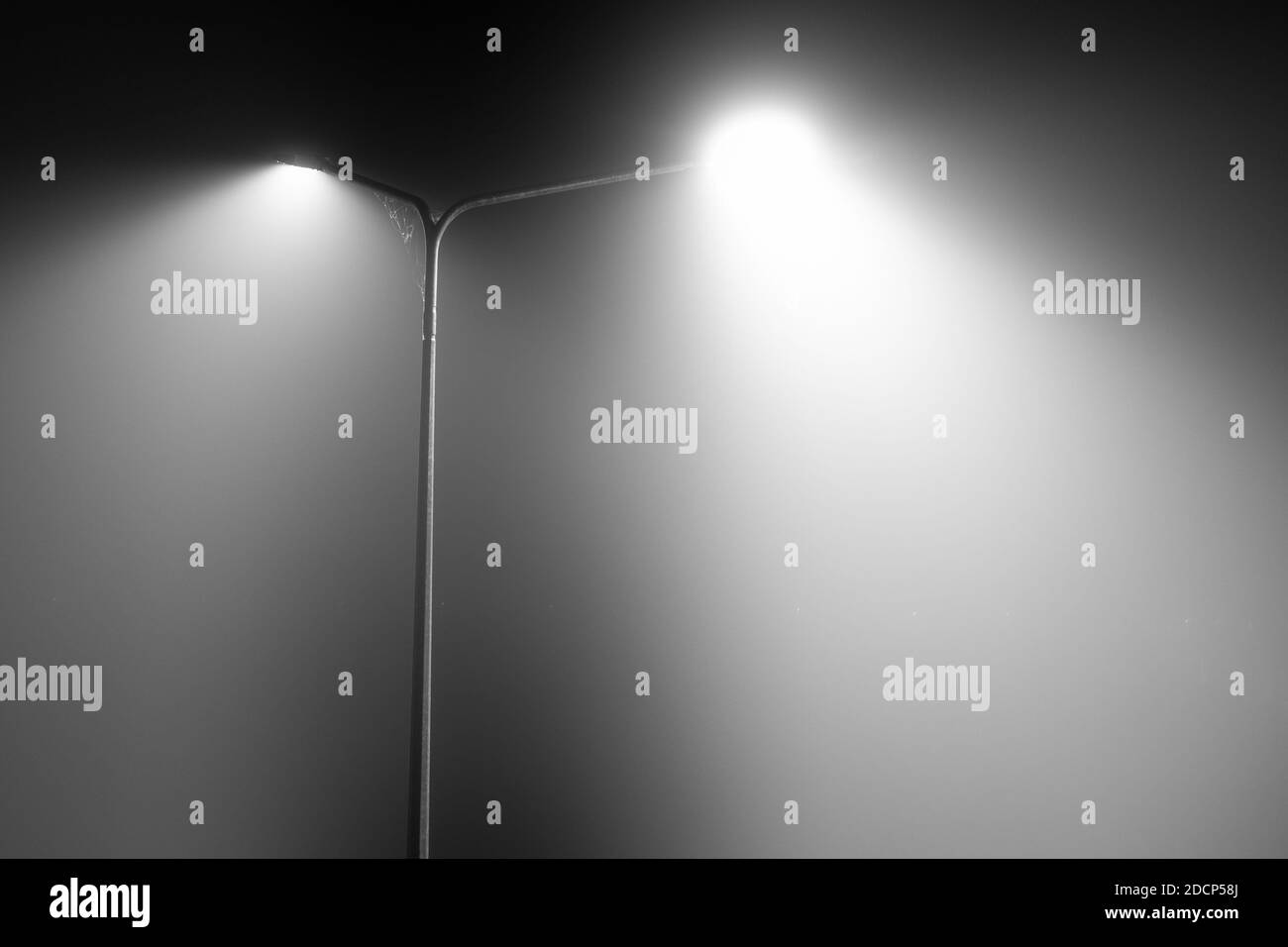 Ray of light from a street lamp on a background of black night sky ...