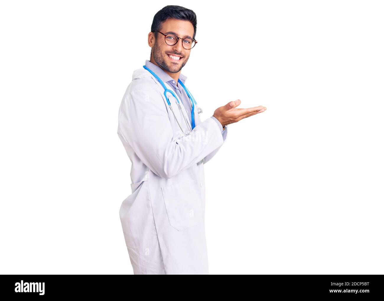 Young hispanic man wearing doctor uniform and stethoscope pointing ...