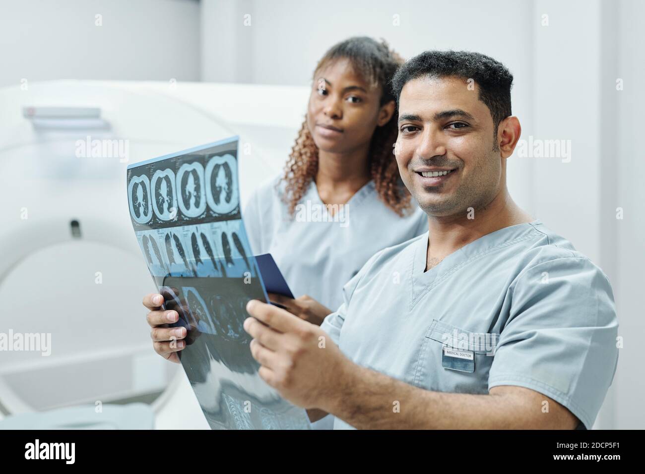 Happy mixed-race radiologist and his African female assistant looking ...