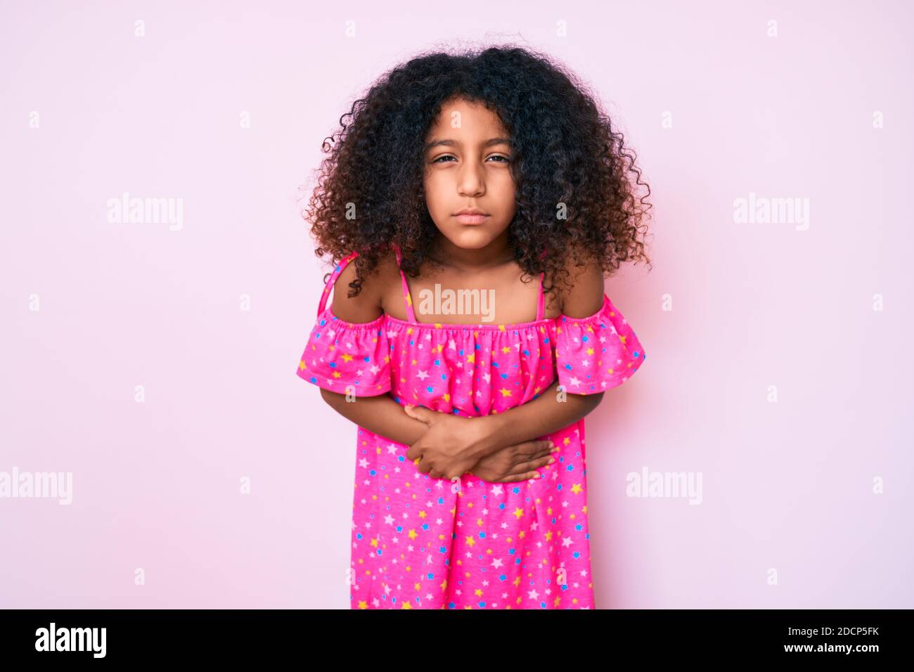 African american child with curly hair wearing casual dress with hand ...