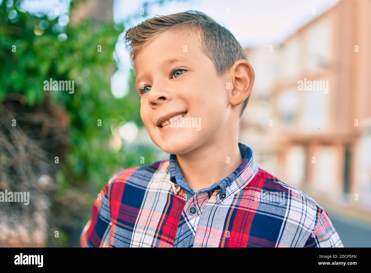 Adorable caucasian boy smiling happy standing at the city Stock Photo - Alamy