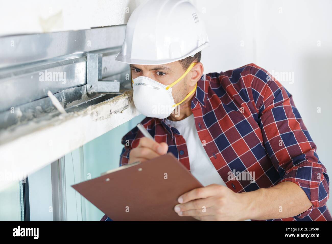man inspecting a derelict property wearing a dust mask Stock Photo - Alamy