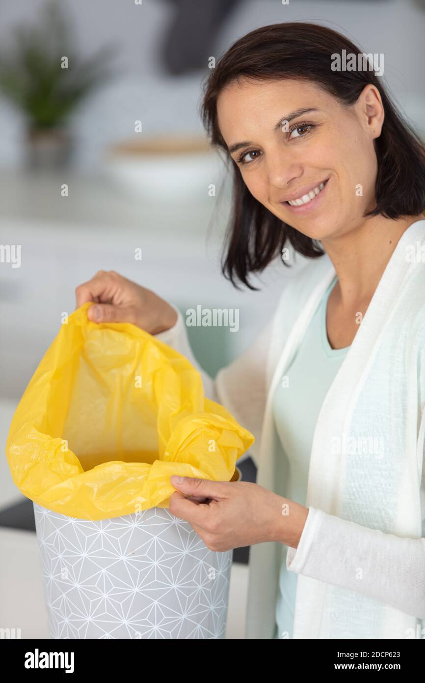 smiling woman changing garbage bags Stock Photo - Alamy