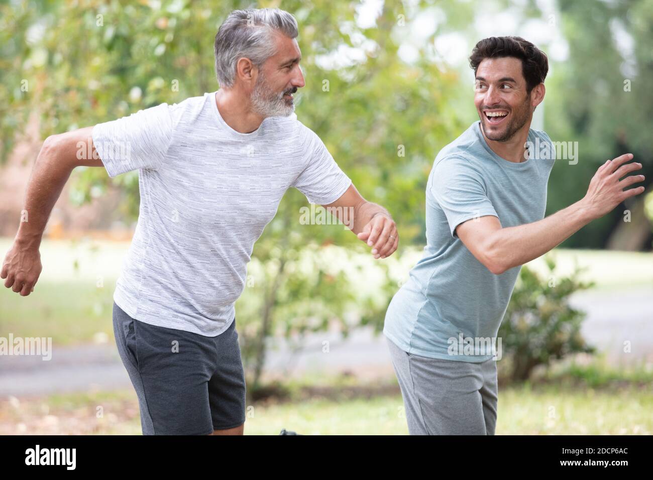 happy father and son jogging together outdoors in park Stock Photo - Alamy