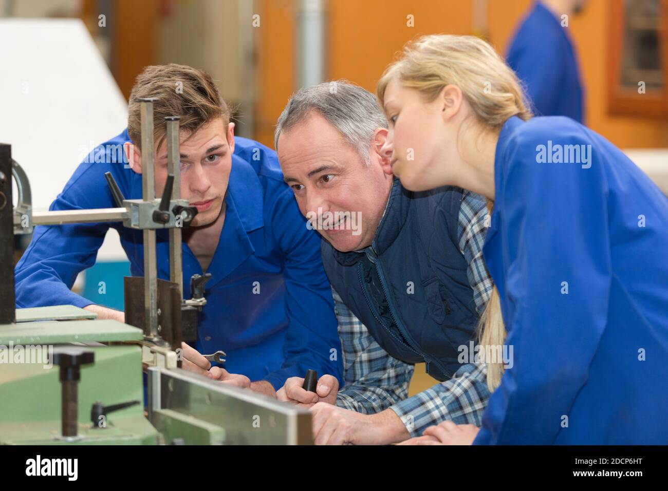 apprentices learning how to use a machine Stock Photo - Alamy