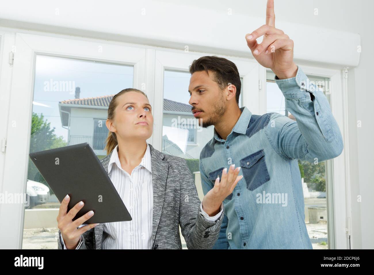 estate agent showing client around property Stock Photo - Alamy