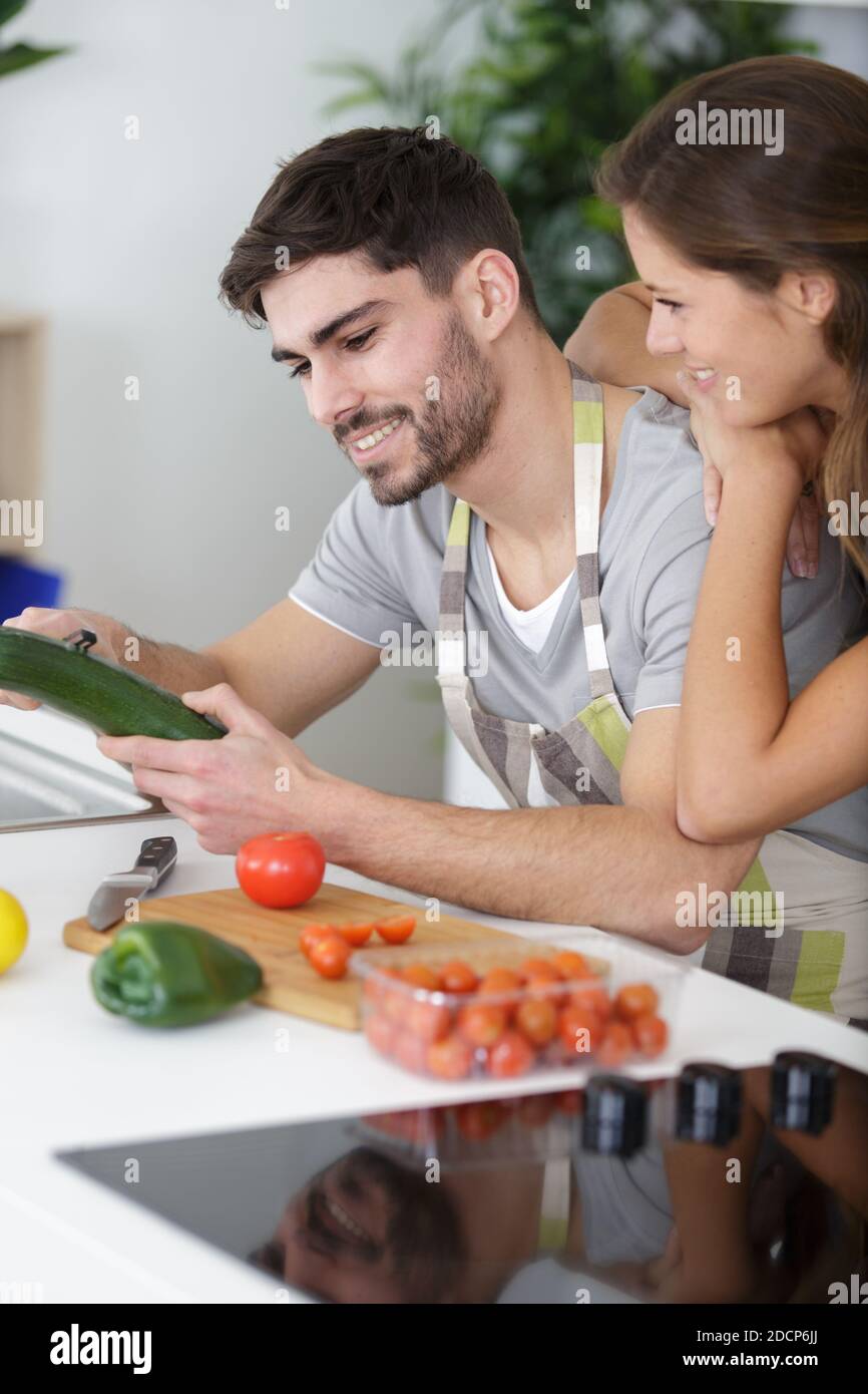 happy man and woman cooking vegetables in kitchen Stock Photo - Alamy