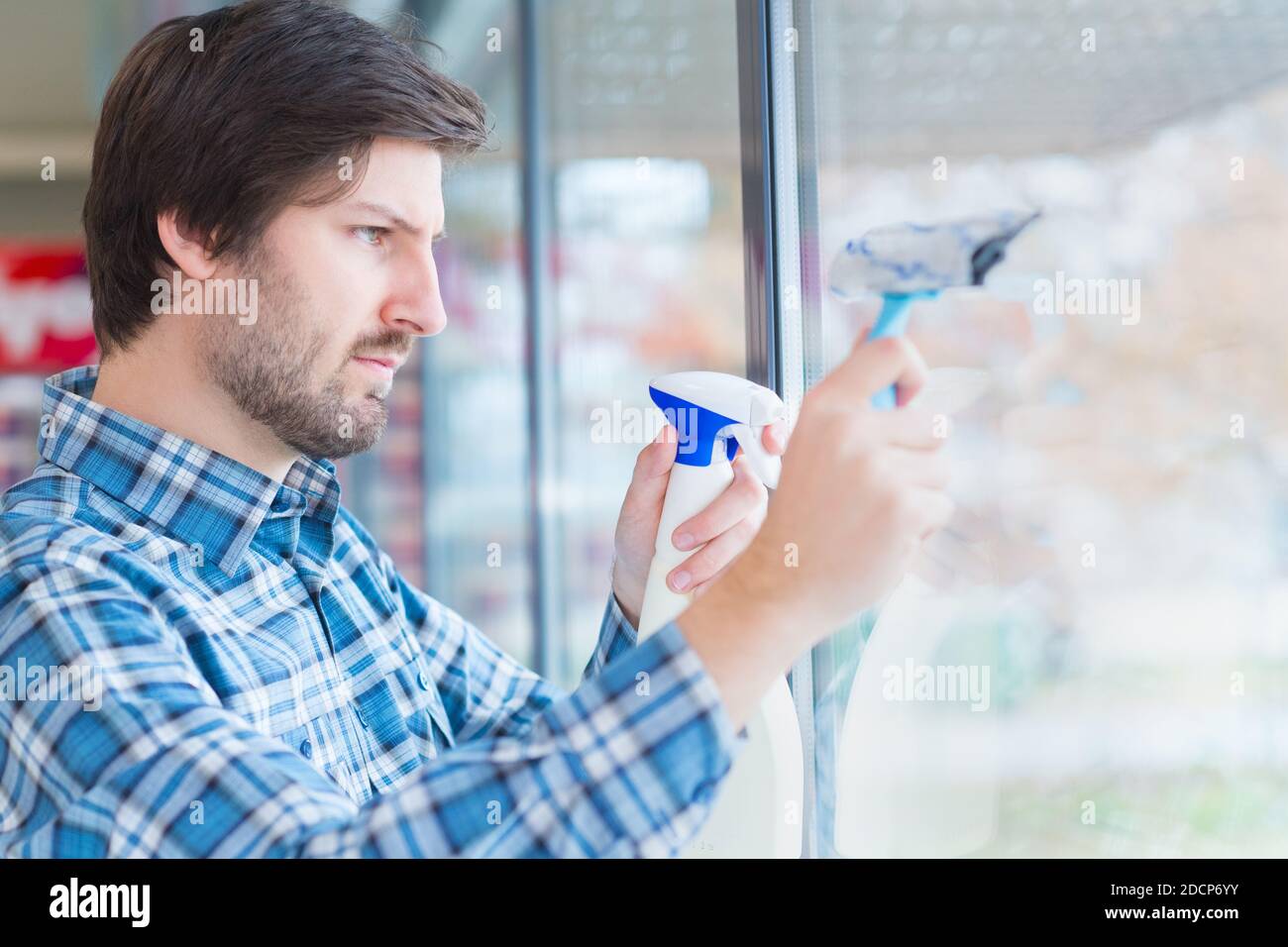 Young man washing windows hi-res stock photography and images - Alamy