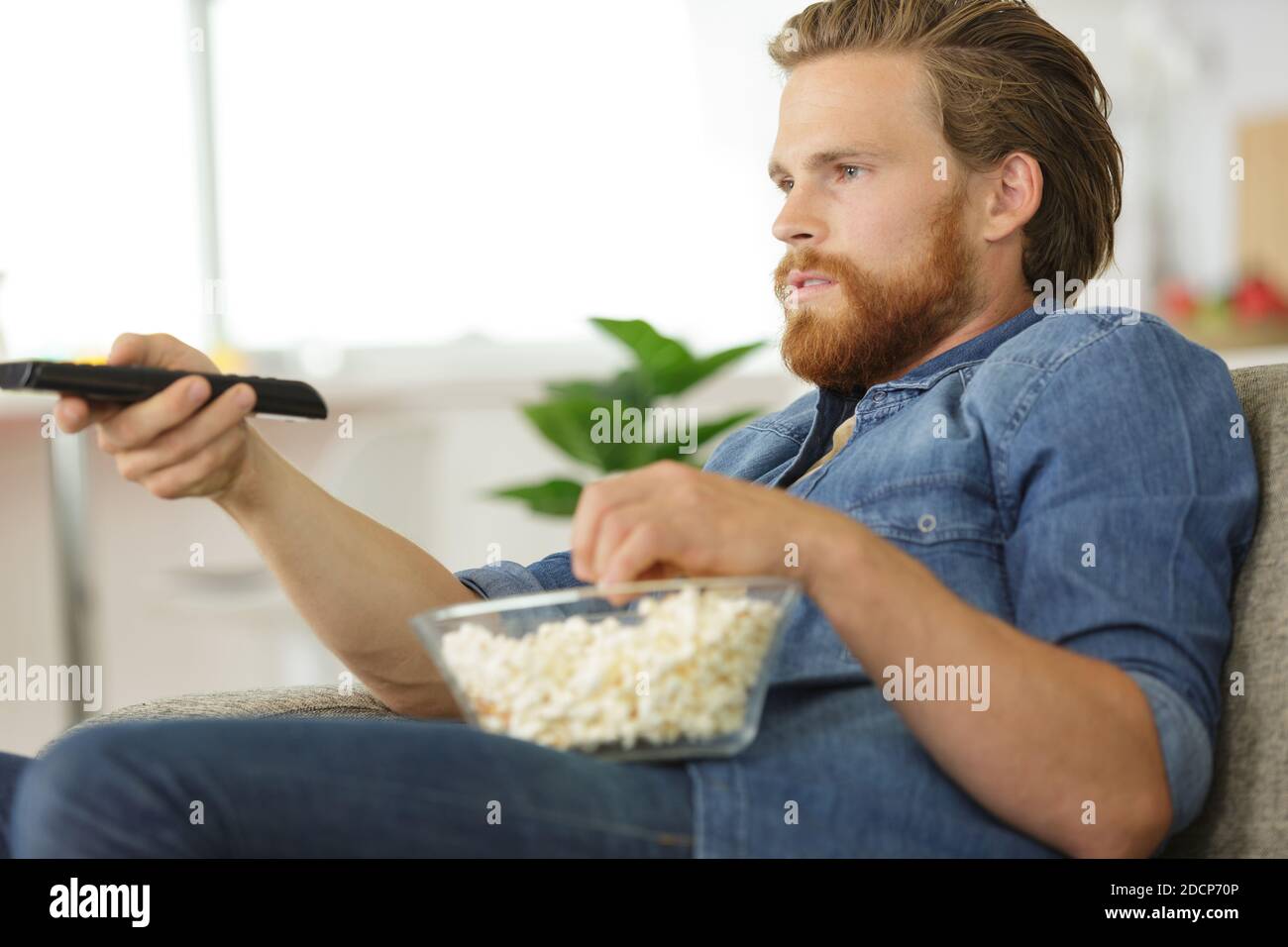 Man watches tv hi-res stock photography and images - Alamy