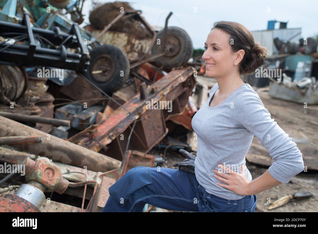 female junkyard worker smiling Stock Photo - Alamy