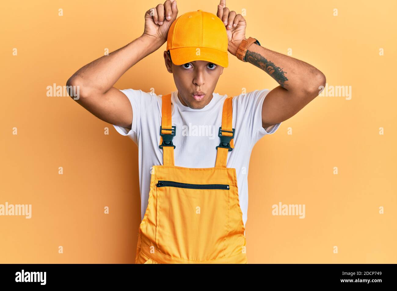 Young handsome african american man wearing handyman uniform over ...