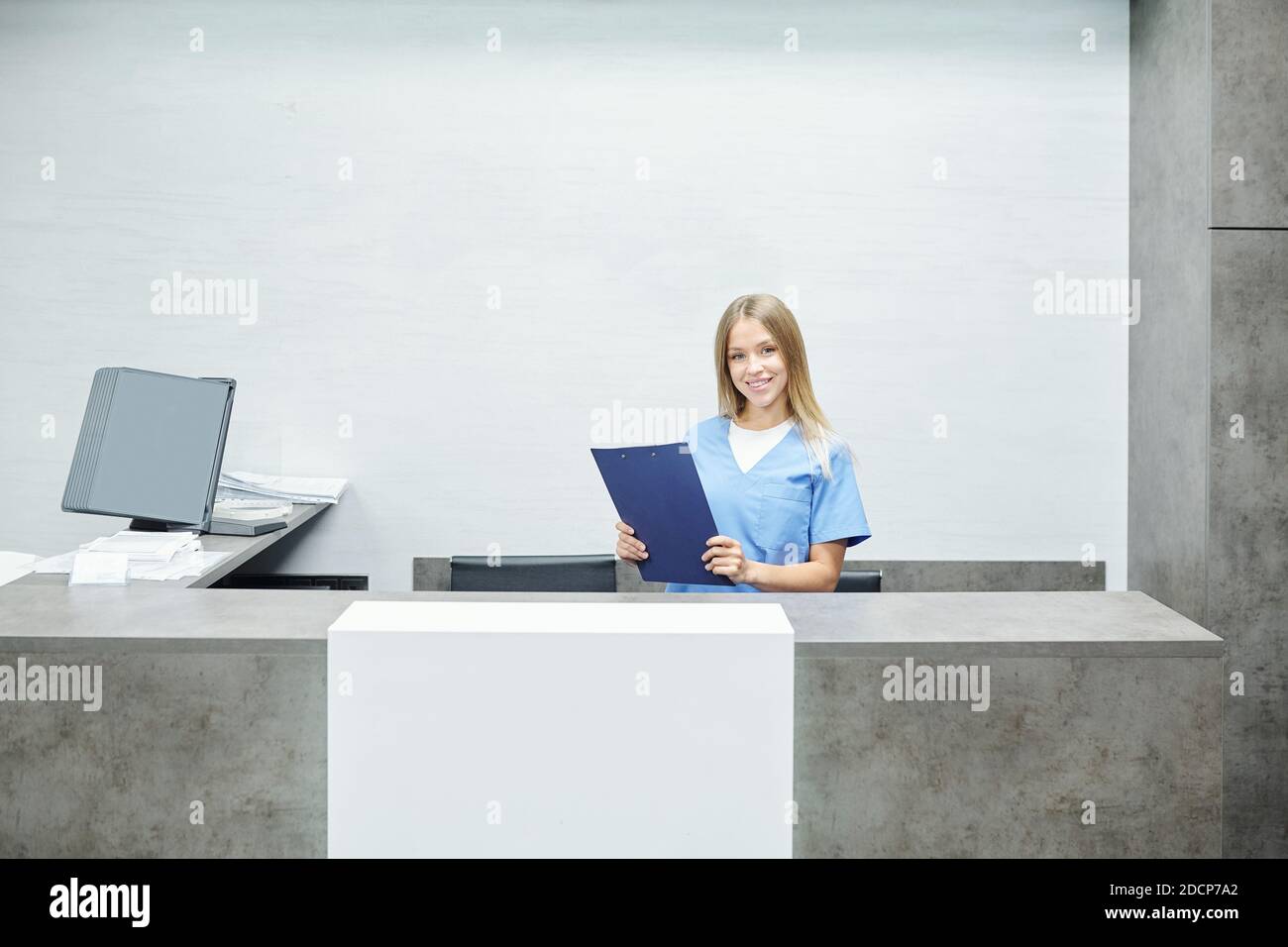 Assistant in blue uniform holding hi-res stock photography and images ...