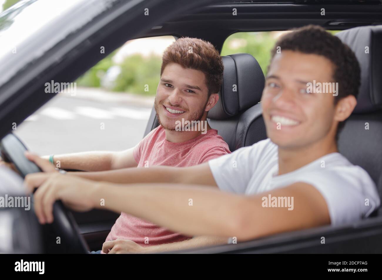 man and friend driving car Stock Photo - Alamy