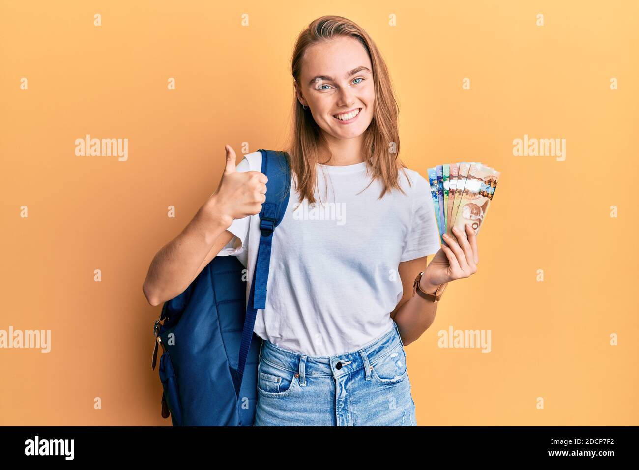 Beautiful blonde woman wearing student backpack and holding canadian ...
