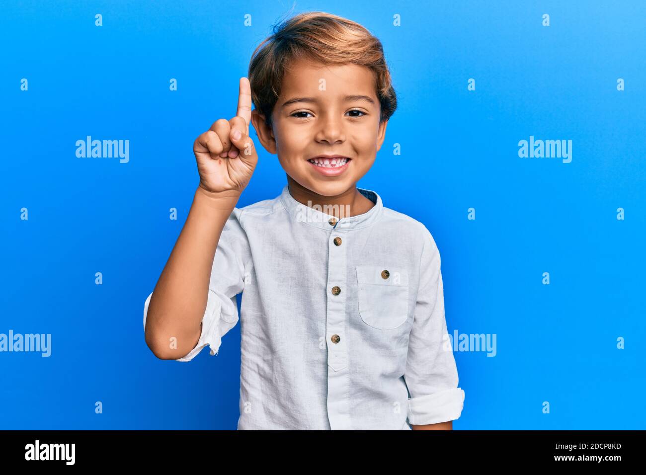 Adorable latin kid wearing casual clothes smiling with an idea or ...