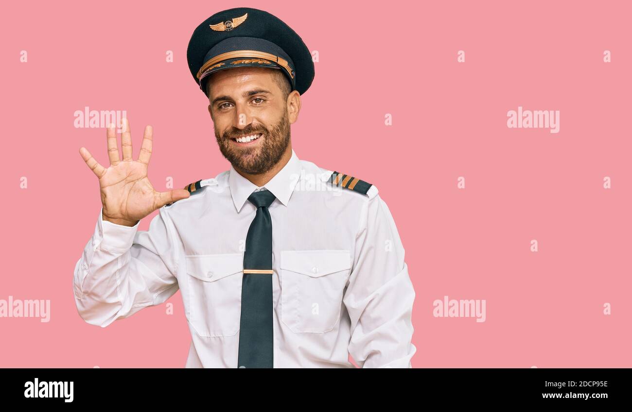 Handsome Man With Beard Wearing Airplane Pilot Uniform Showing And