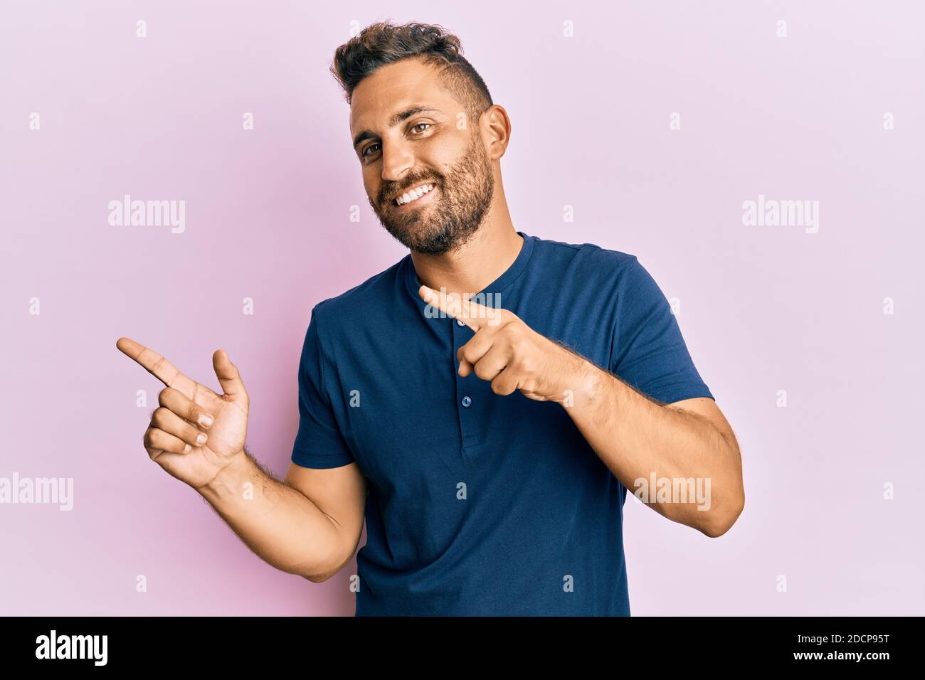 Handsome man with beard wearing casual clothes smiling and looking at ...
