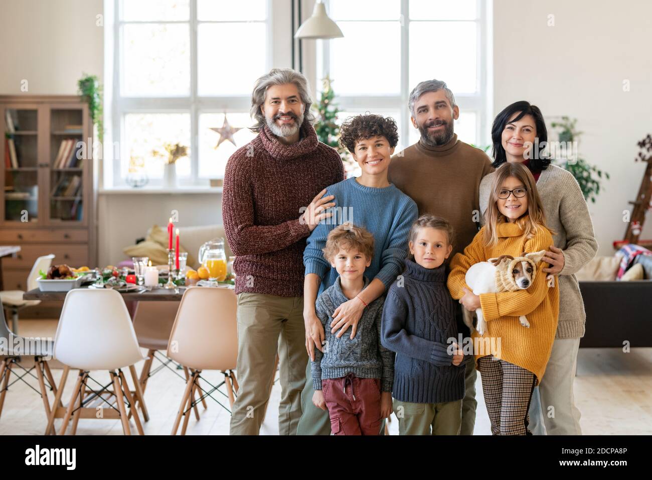 Young large happy family of three generations standing in living-room ...
