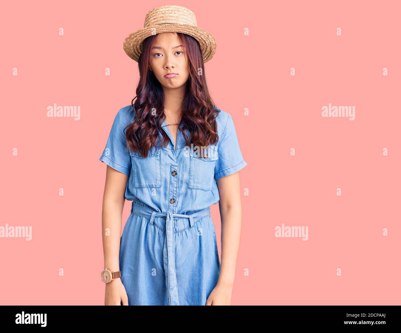 Young beautiful chinese girl wearing summer hat depressed and worry for ...