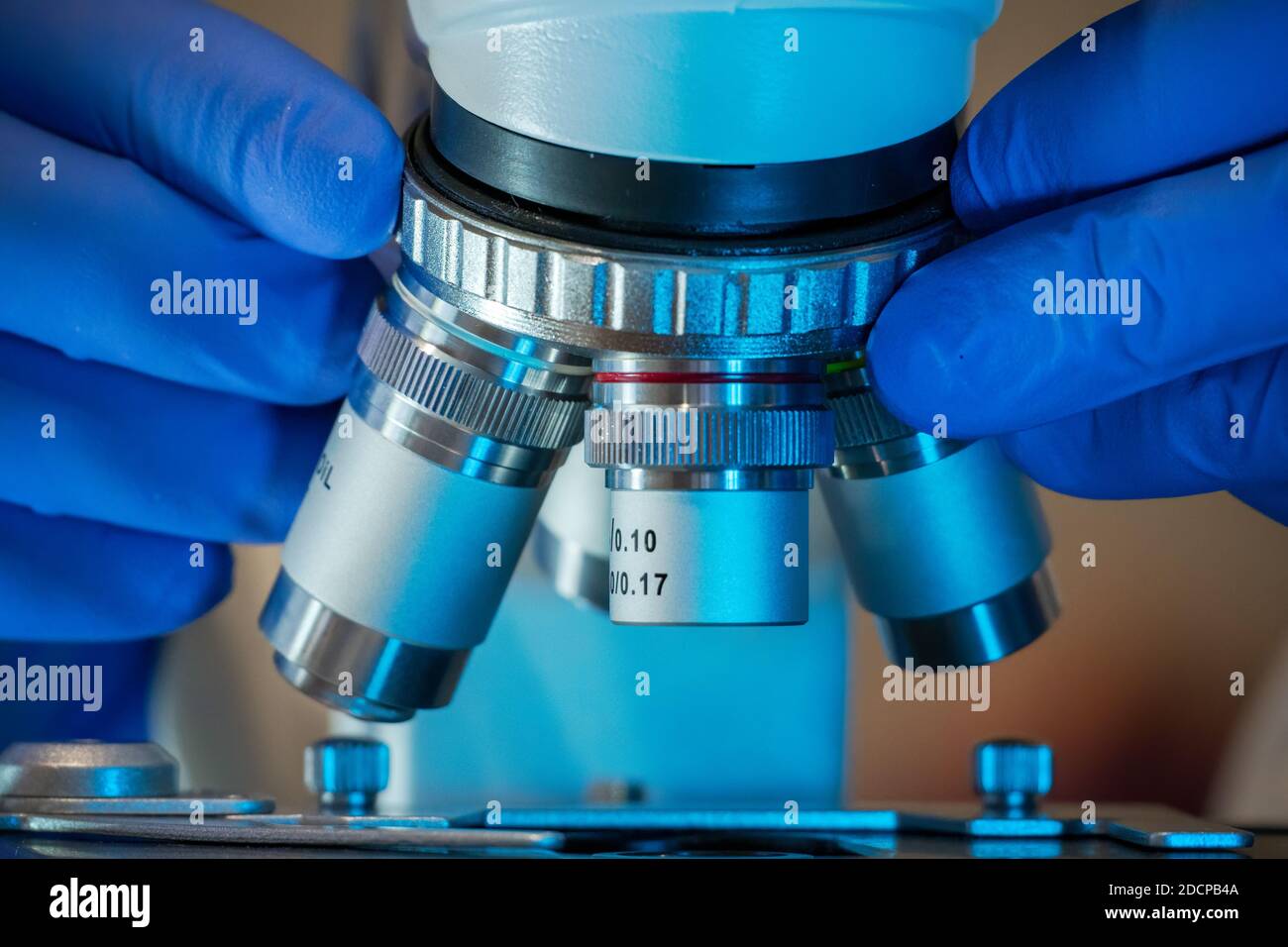 Hands of scientist adjusting microscope in laboratory Stock Photo - Alamy