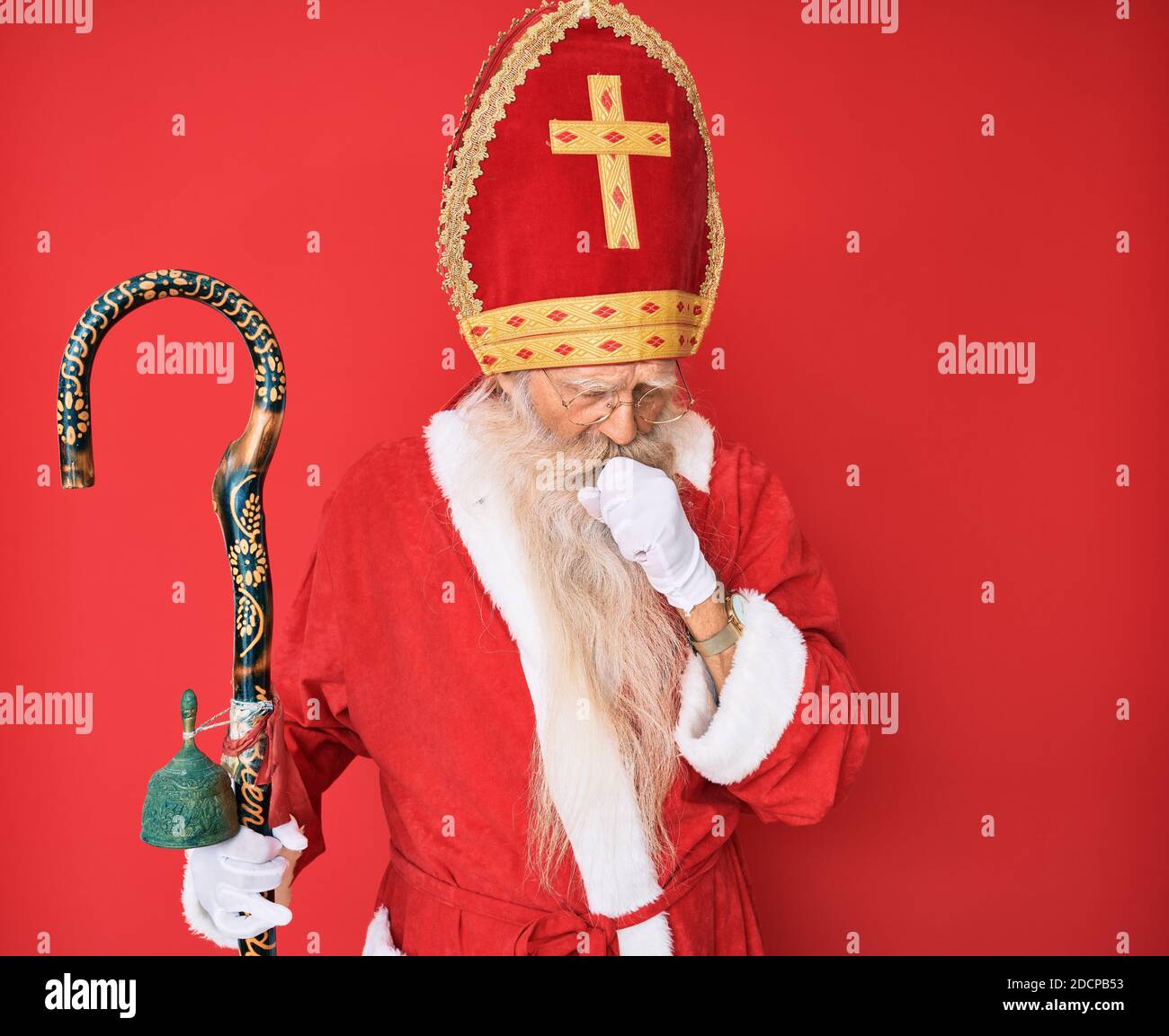Old senior man with grey hair and long beard wearing traditional saint ...
