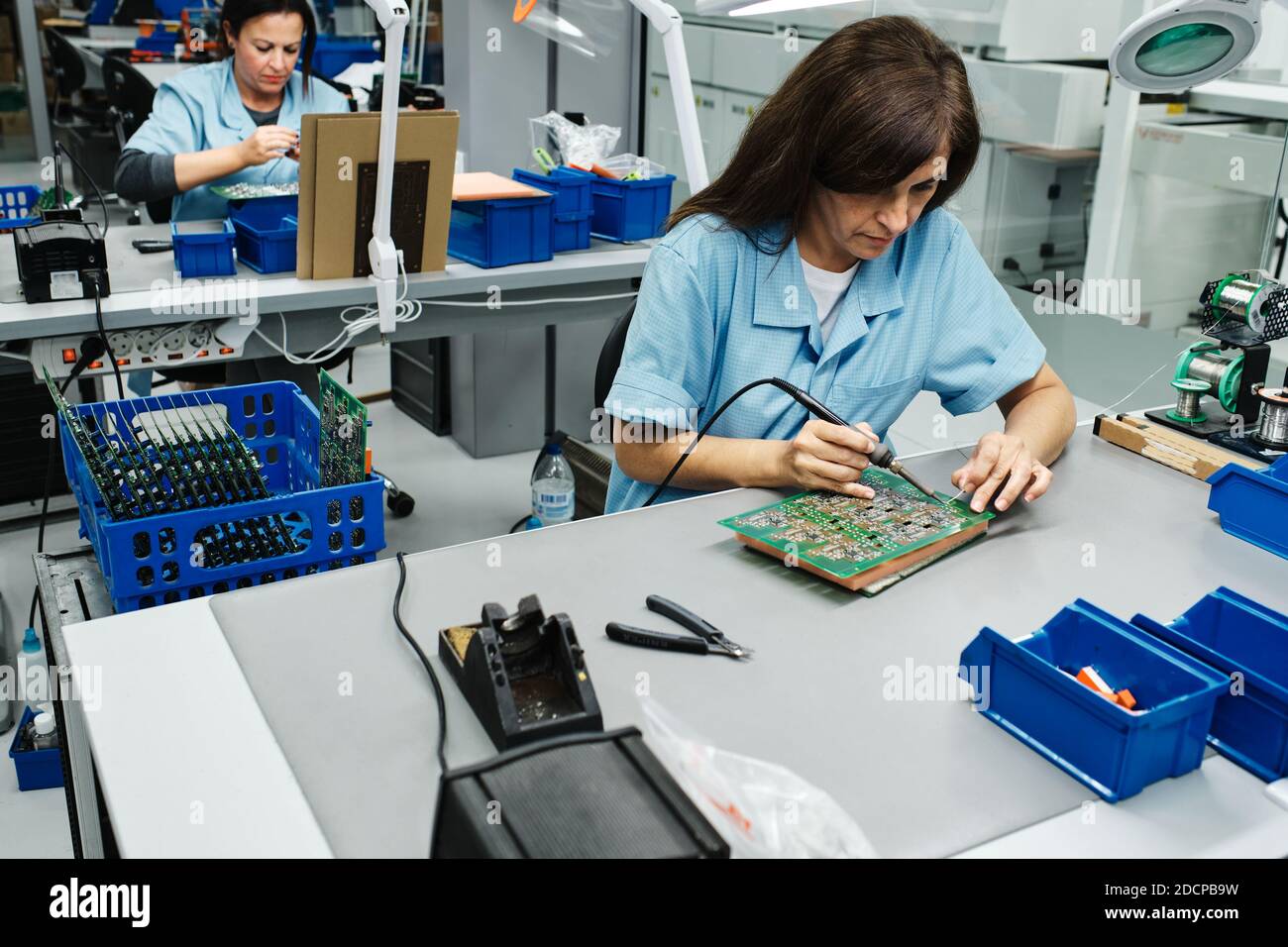 several employees working in a factory on your table Stock Photo - Alamy