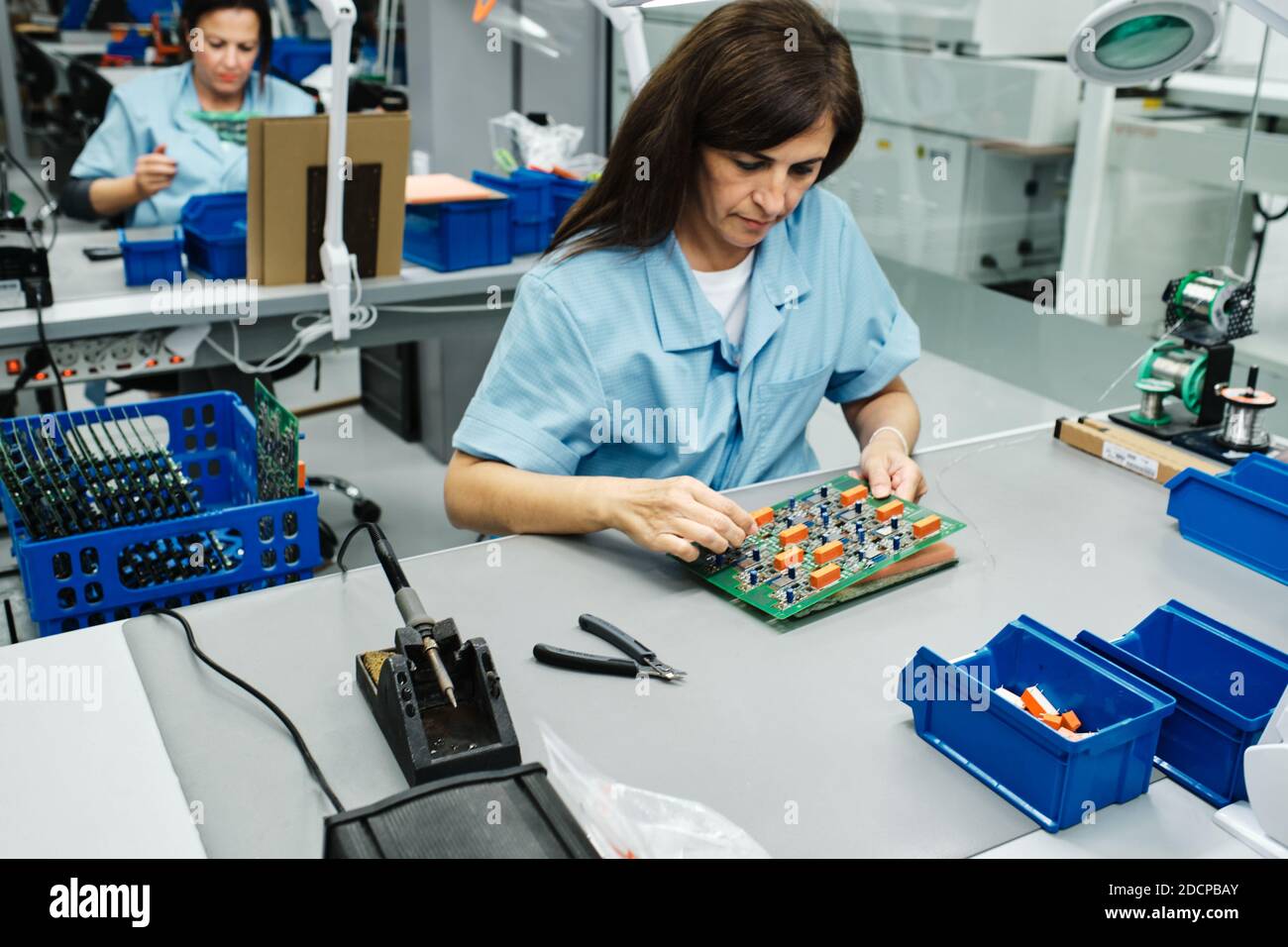 several employees working in a factory on your table Stock Photo - Alamy
