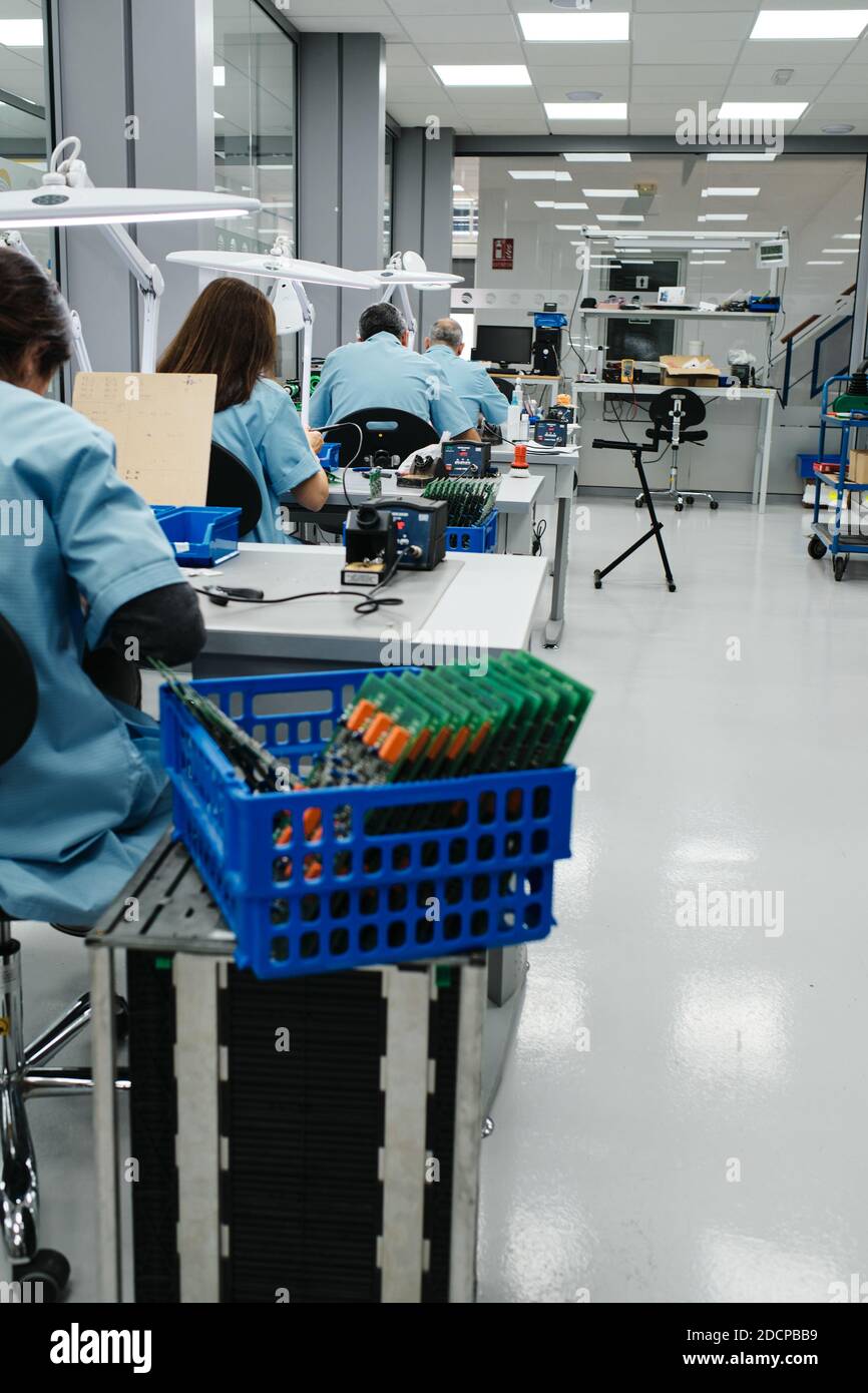 several workers make the products on their work table Stock Photo - Alamy