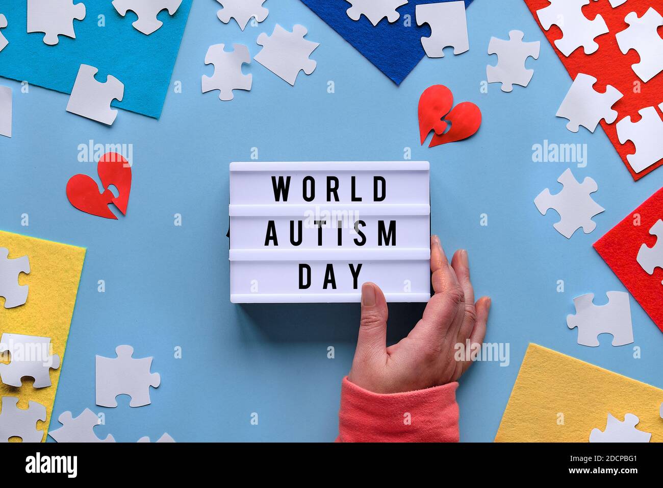 Hand hold lightbox, text World Autism Day. Creative design for April 2 ...
