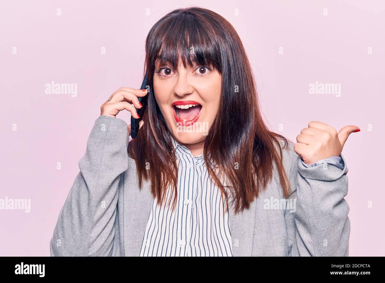 Young plus size woman having conversation talking on the smartphone ...