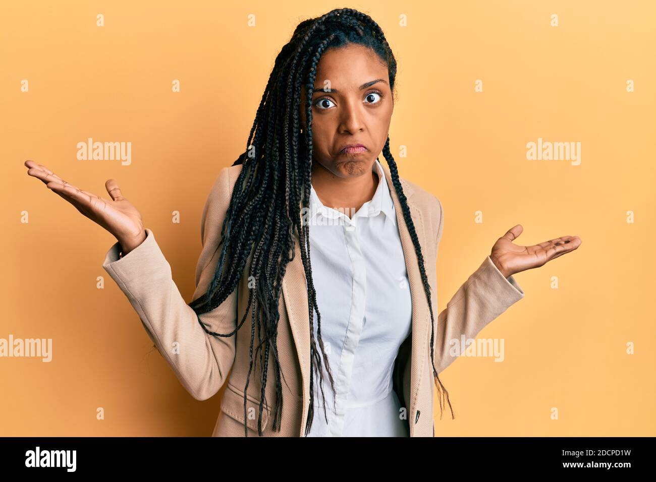 African american woman wearing business jacket clueless and confused ...