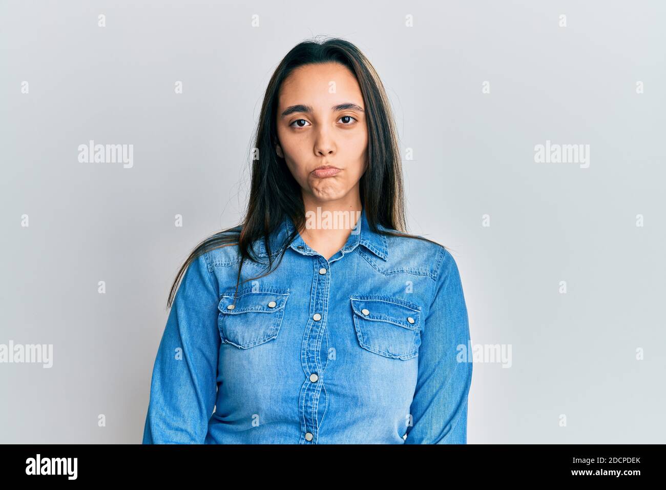 Young hispanic woman wearing casual denim jacket approving doing ...