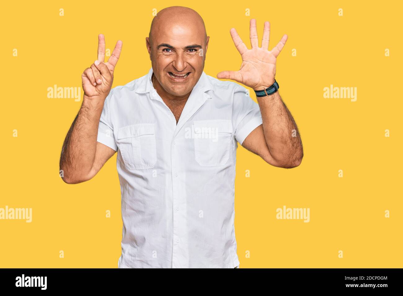 Mature middle east man with mustache wearing casual white shirt showing ...