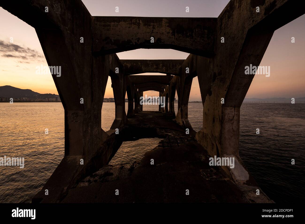 Beautiful ocean sunset view framed on concrete structure on island ...