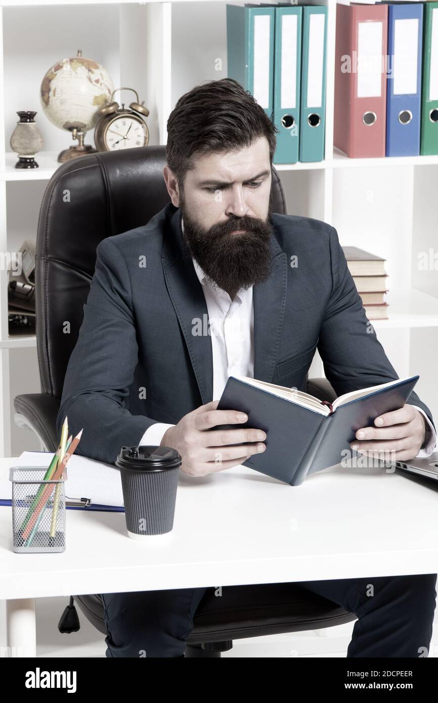 Reading authority business book. Man bearded hipster boss sit armchair ...