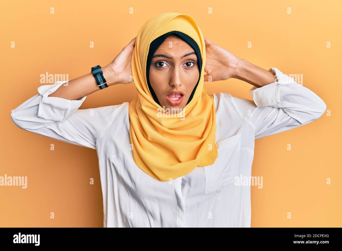 Young brunette arab woman wearing traditional islamic hijab scarf crazy ...