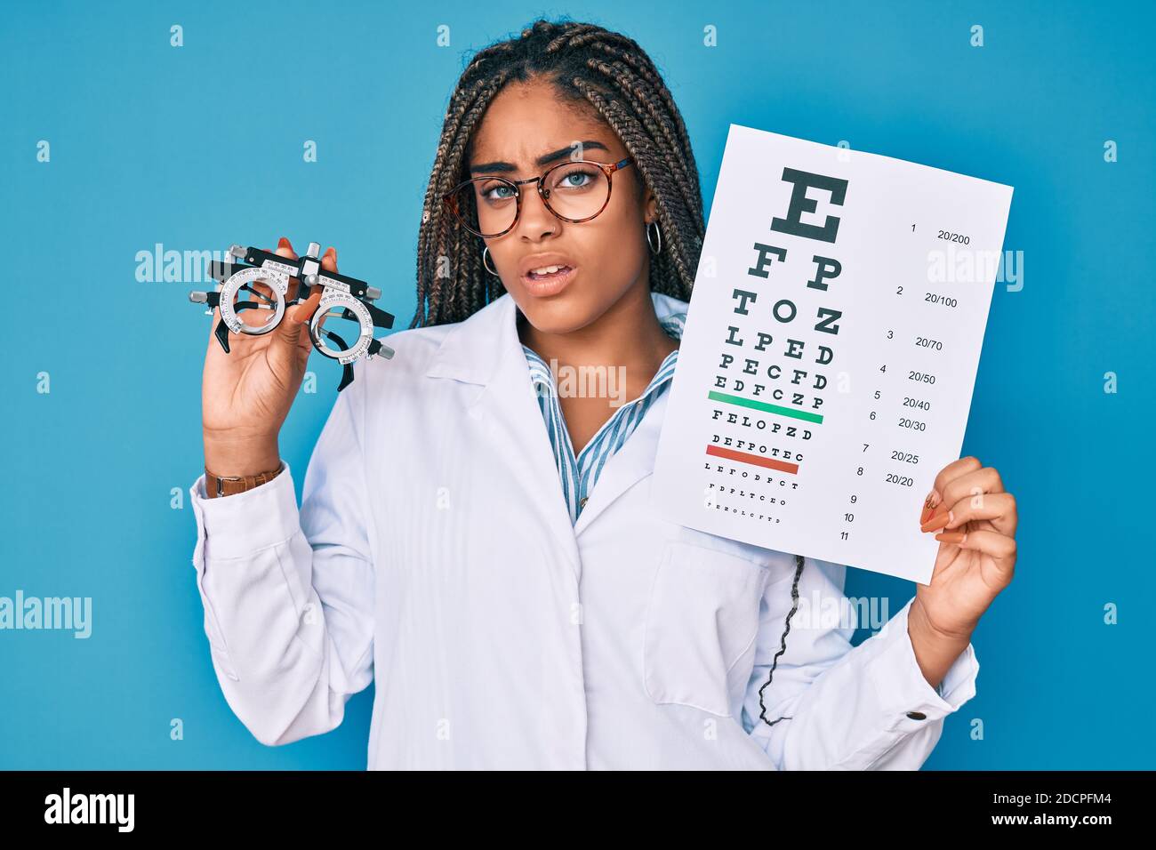 Young african american optician woman with braids holding optometry ...