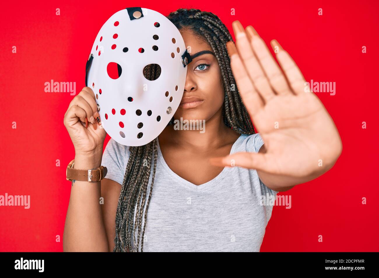 Young african american woman with braids wearing hockey mask with open ...