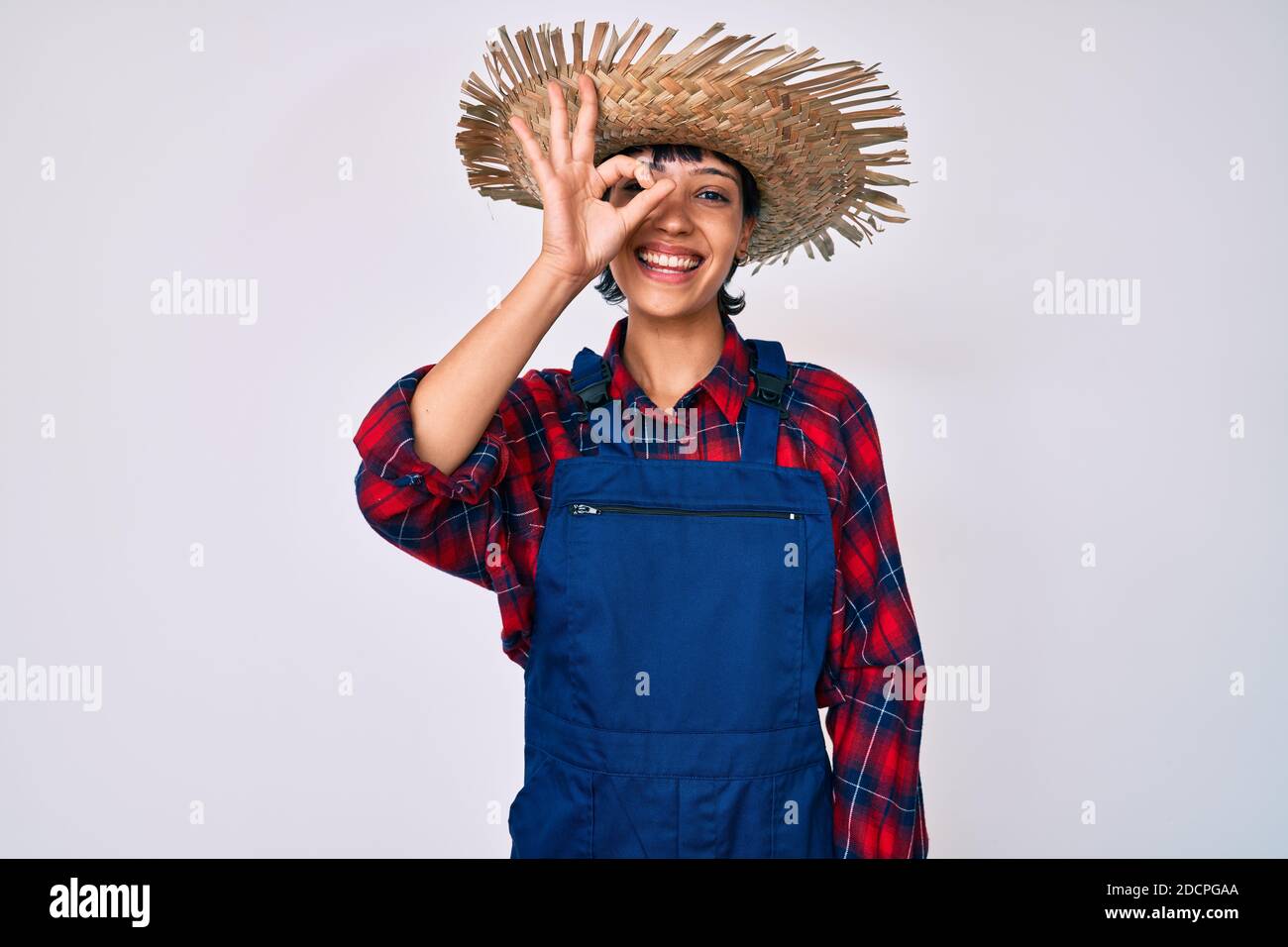 Beautiful brunettte woman wearing farmer clothes smiling happy doing ok ...