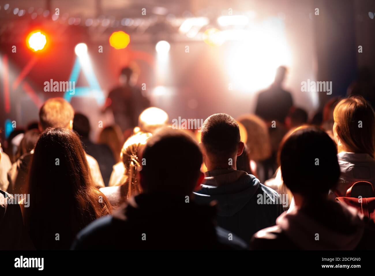 Photo of many people enjoying rock concert in nightclub Stock Photo - Alamy