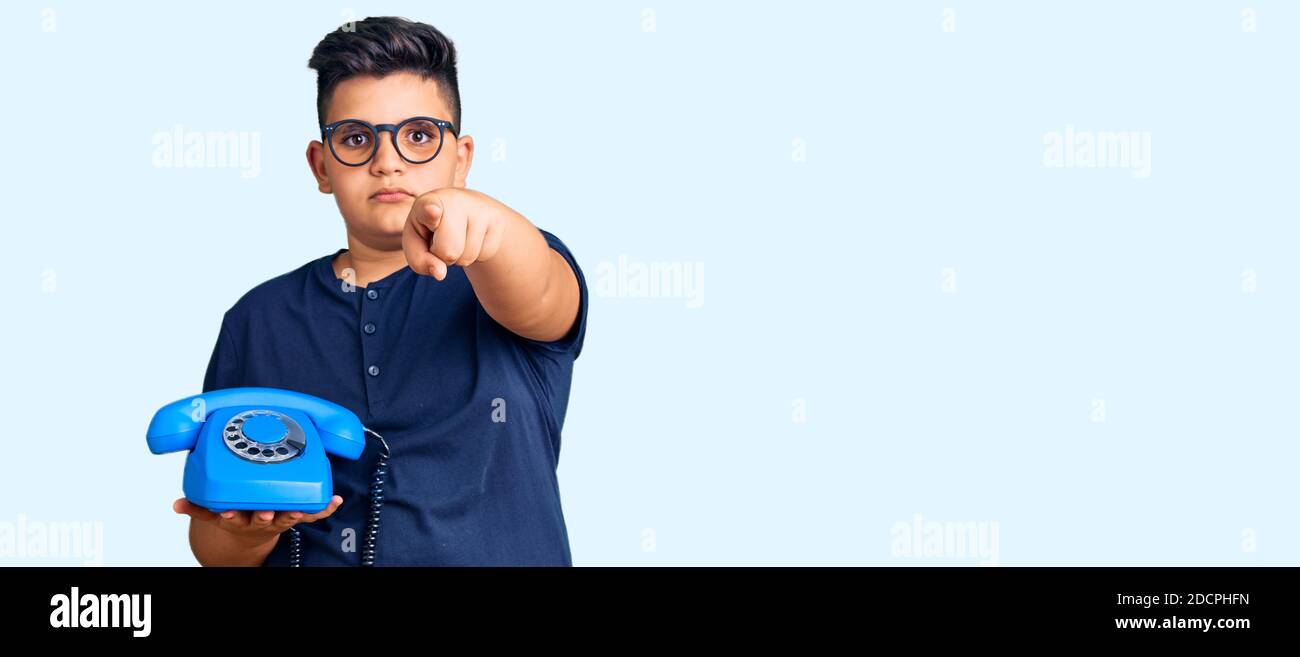 Little boy kid using vintage telephone pointing with finger to the ...