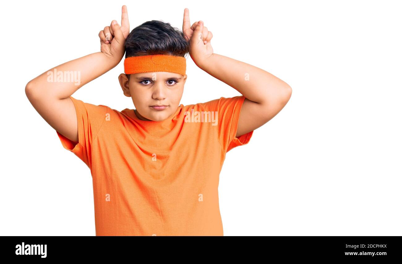 Little boy kid wearing sportswear doing funny gesture with finger over ...