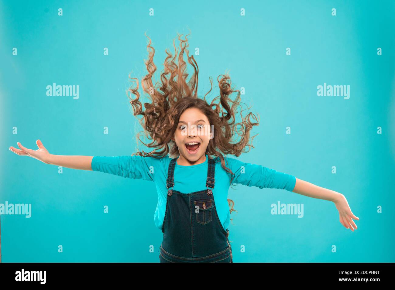 Feeling active and energetic. Energetic little girl with long brunette ...
