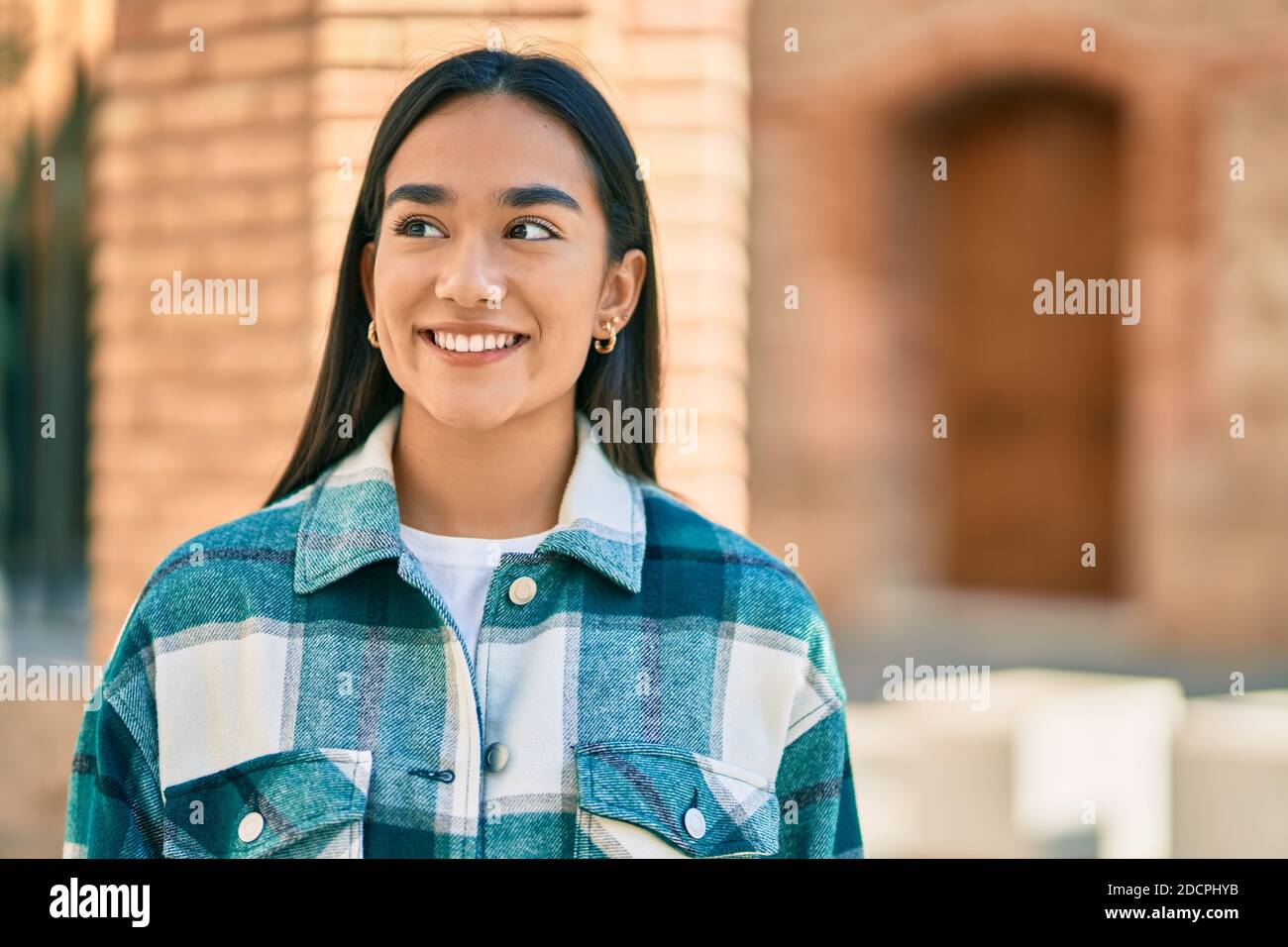Young latin girl smiling happy standing at the city Stock Photo - Alamy
