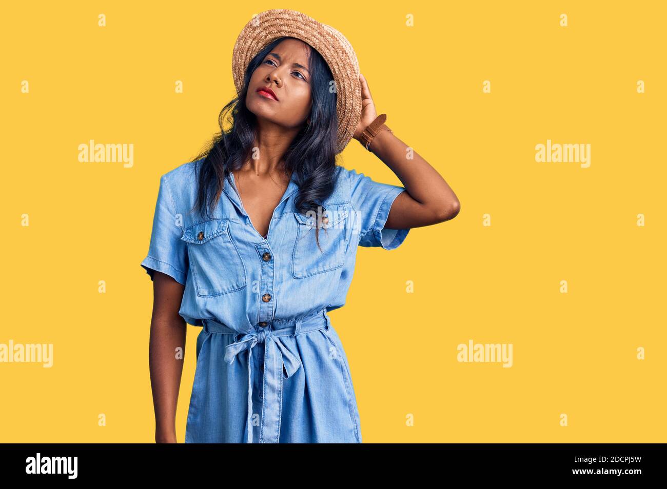Young indian girl wearing summer hat confuse and wondering about ...
